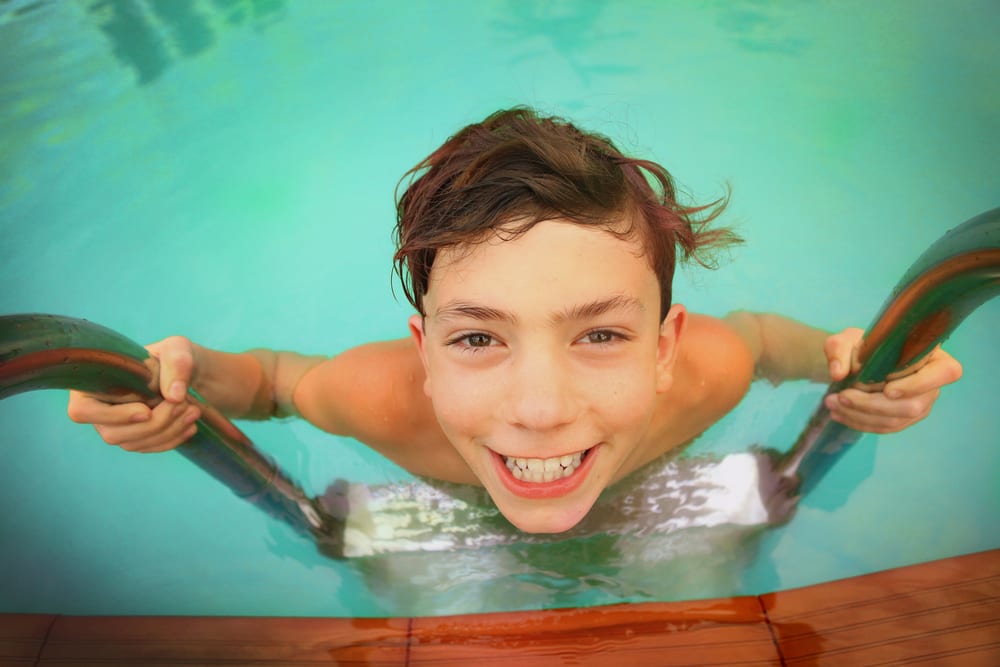 boy getting out of pool - Wyoming Department of Health