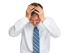 man holding head - Wyoming Department of Health